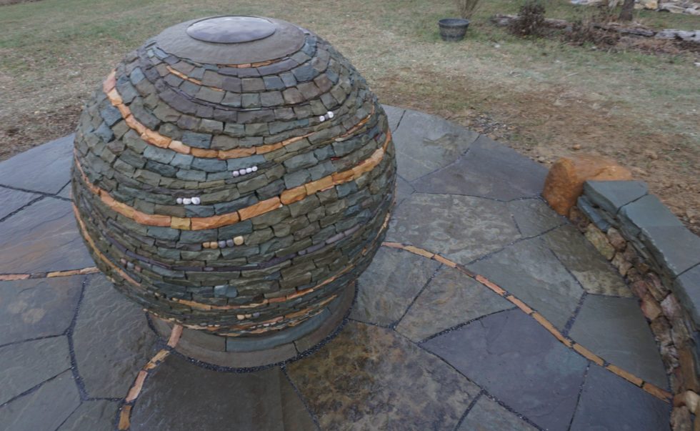 land art installation | dry stone wall patio and sphere sculpture